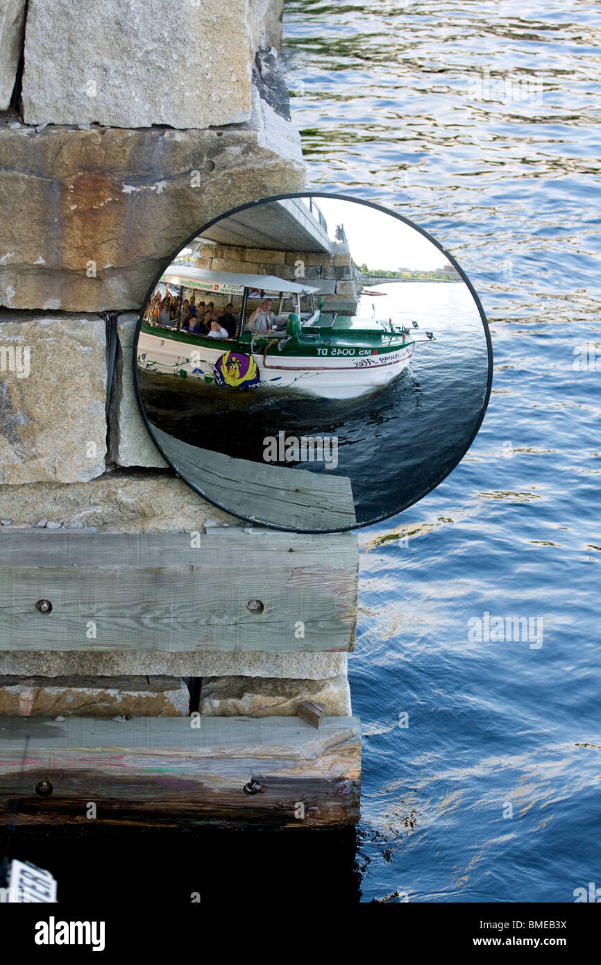 Distorted reflecion of Duck Boat "Arborway Alex" going under a bridge ...