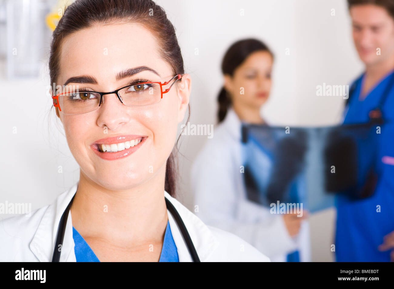 beautiful young health care workers in hospital, background is her ...
