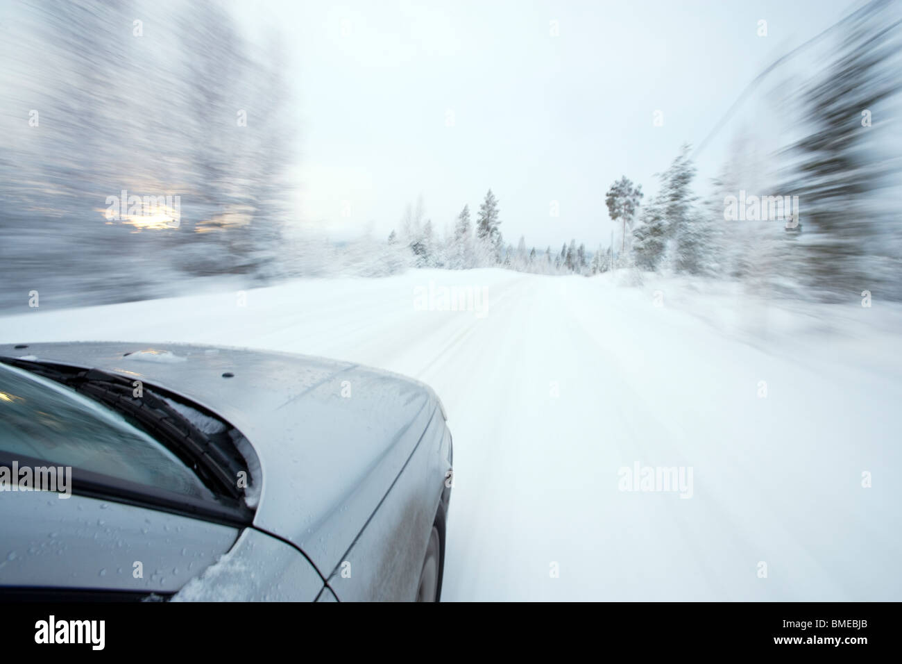 Car moving on snow covered road Stock Photo - Alamy