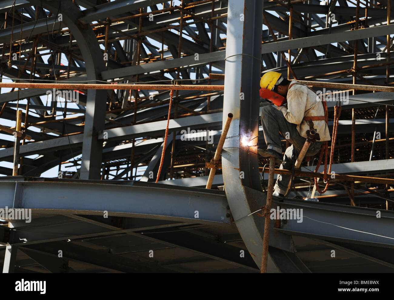 Worker welding steel frame in a construction site, 2010 Shanghai World ...