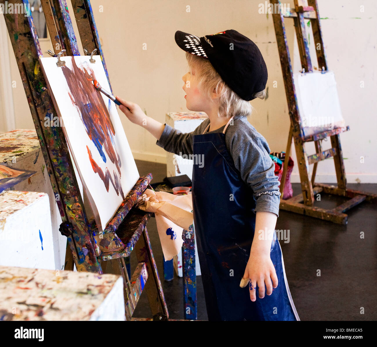 Child artist concentrates painting hi-res stock photography and images ...