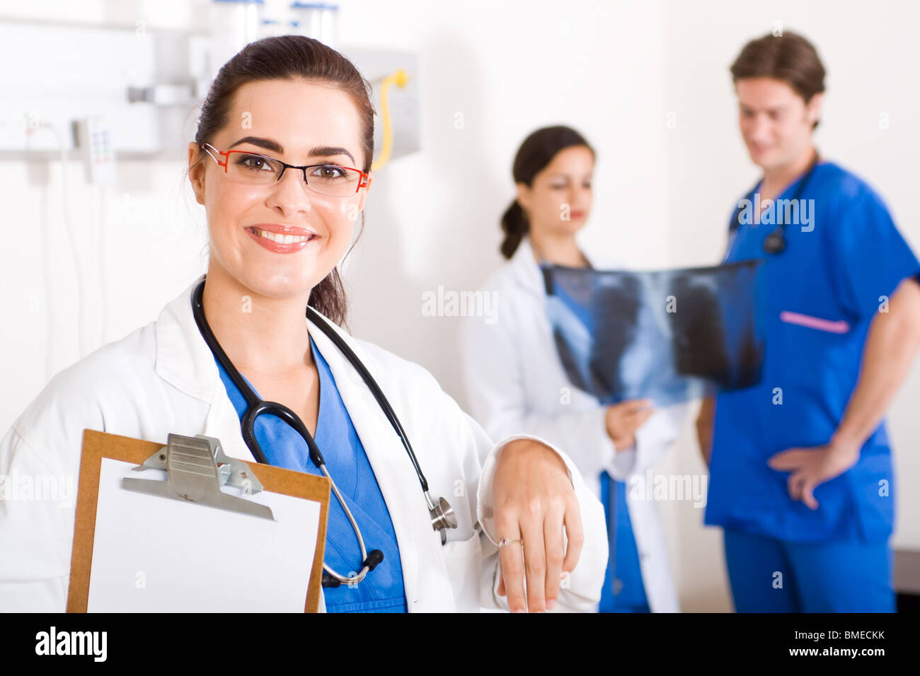 beautiful young health care workers in hospital, background is her ...
