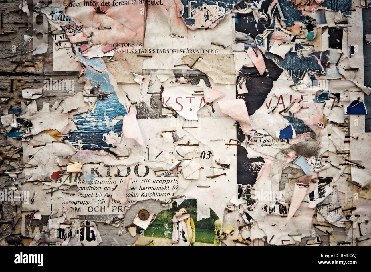 View of torn poster on wall Stock Photo - Alamy