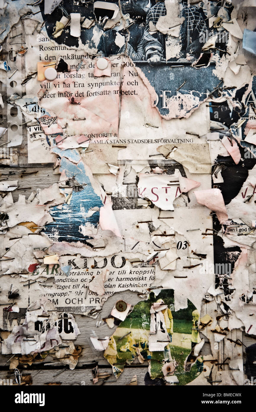 View of torn poster on wall Stock Photo - Alamy