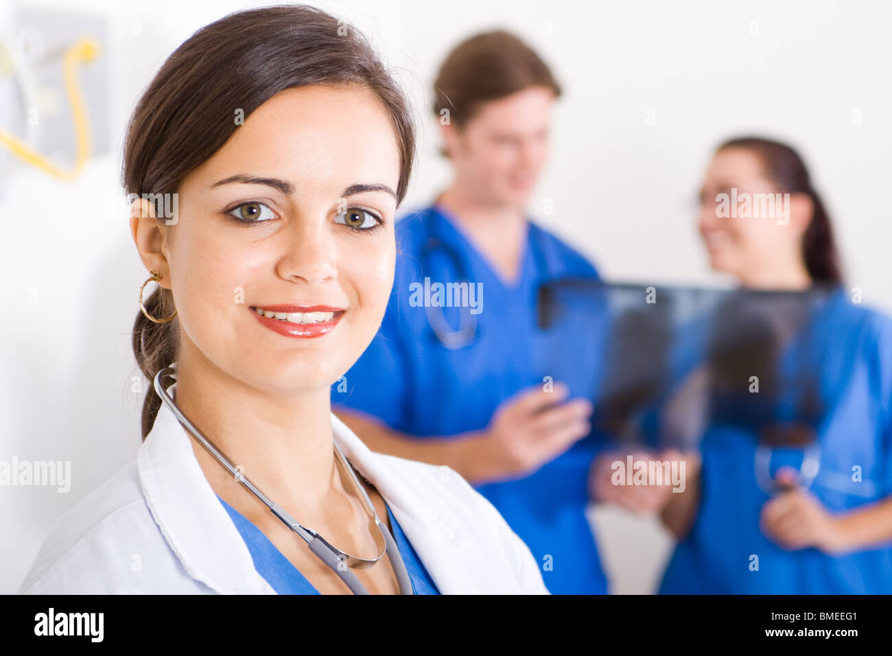 beautiful young health care workers in hospital, background is her ...