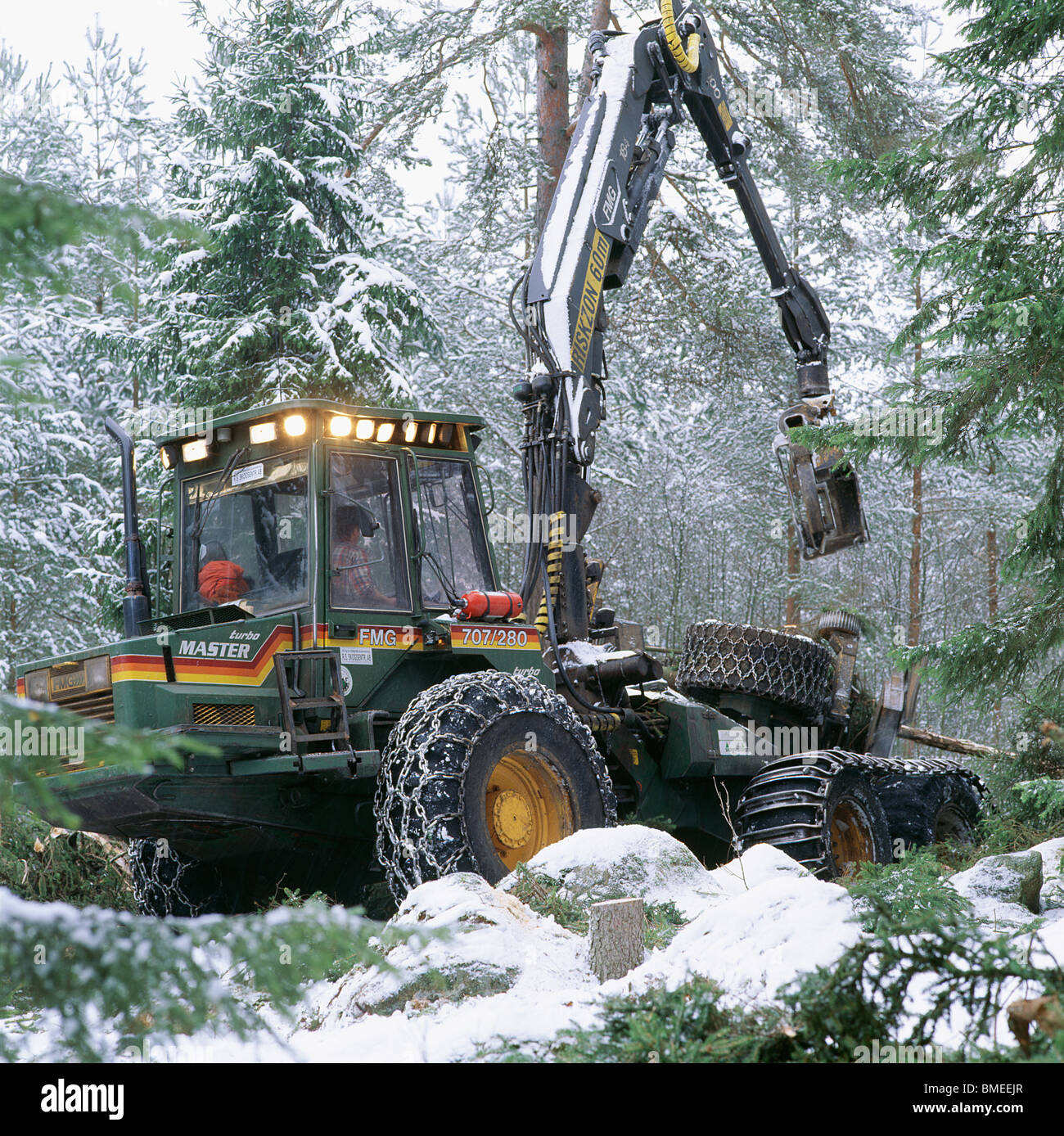 View of mobile crane covered with snow in forest Stock Photo - Alamy