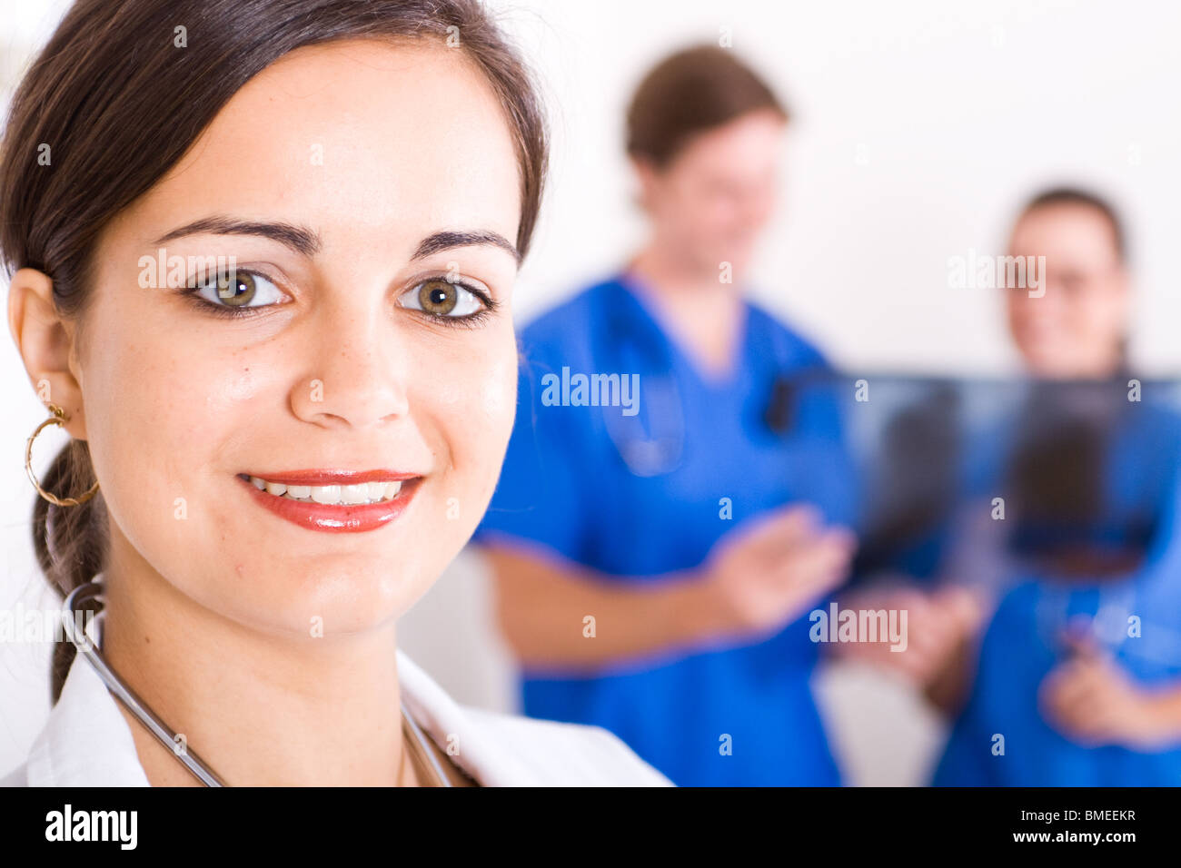 beautiful young health care workers in hospital, background is her ...