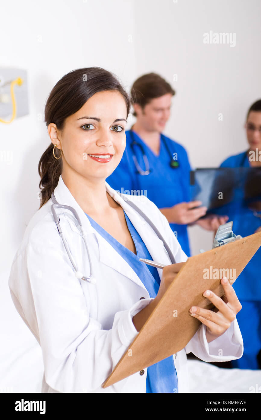 beautiful young health care workers in hospital, background is her ...