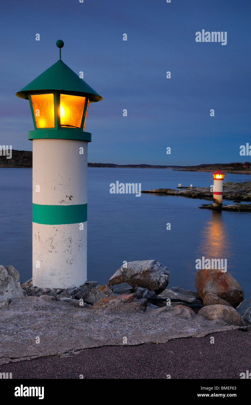 Scandinavia, Sweden, Vastkusten, View of illuminated lighthouse on sea ...