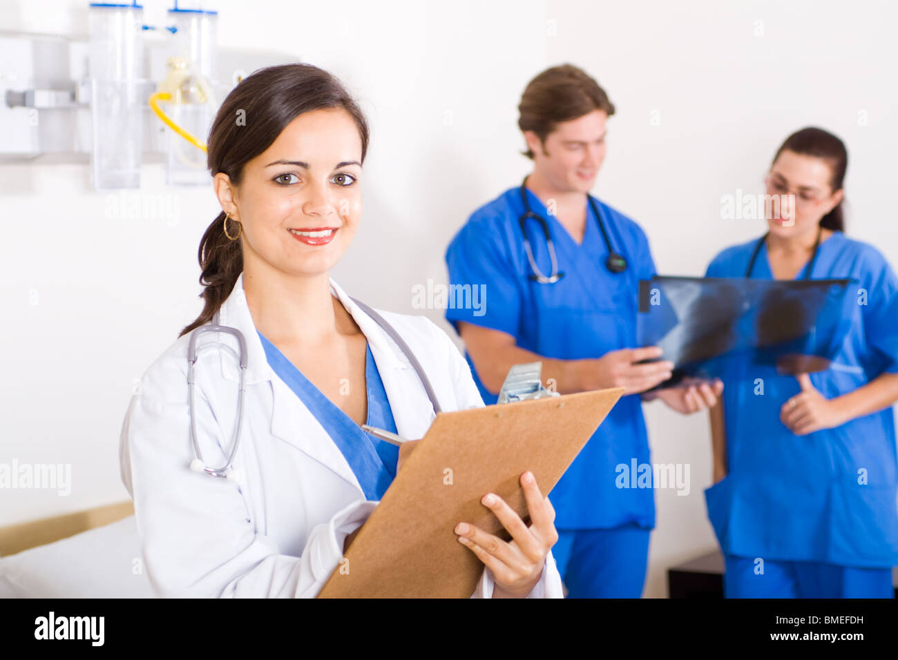 beautiful young health care workers in hospital, background is her ...