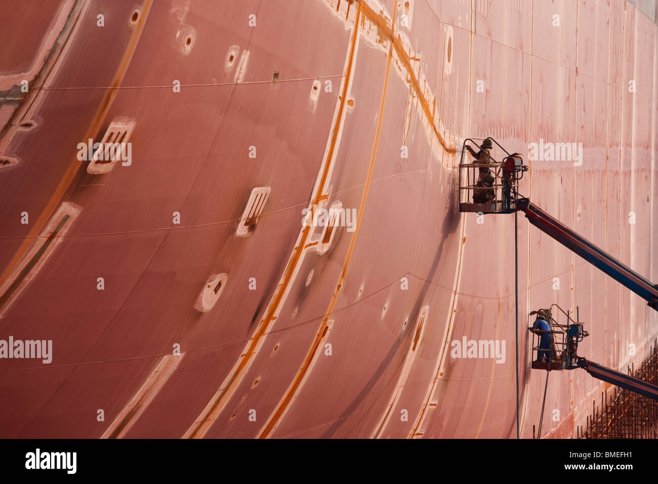 Workers working on the body of a large ship, Shanghai Waigaoqiao ...