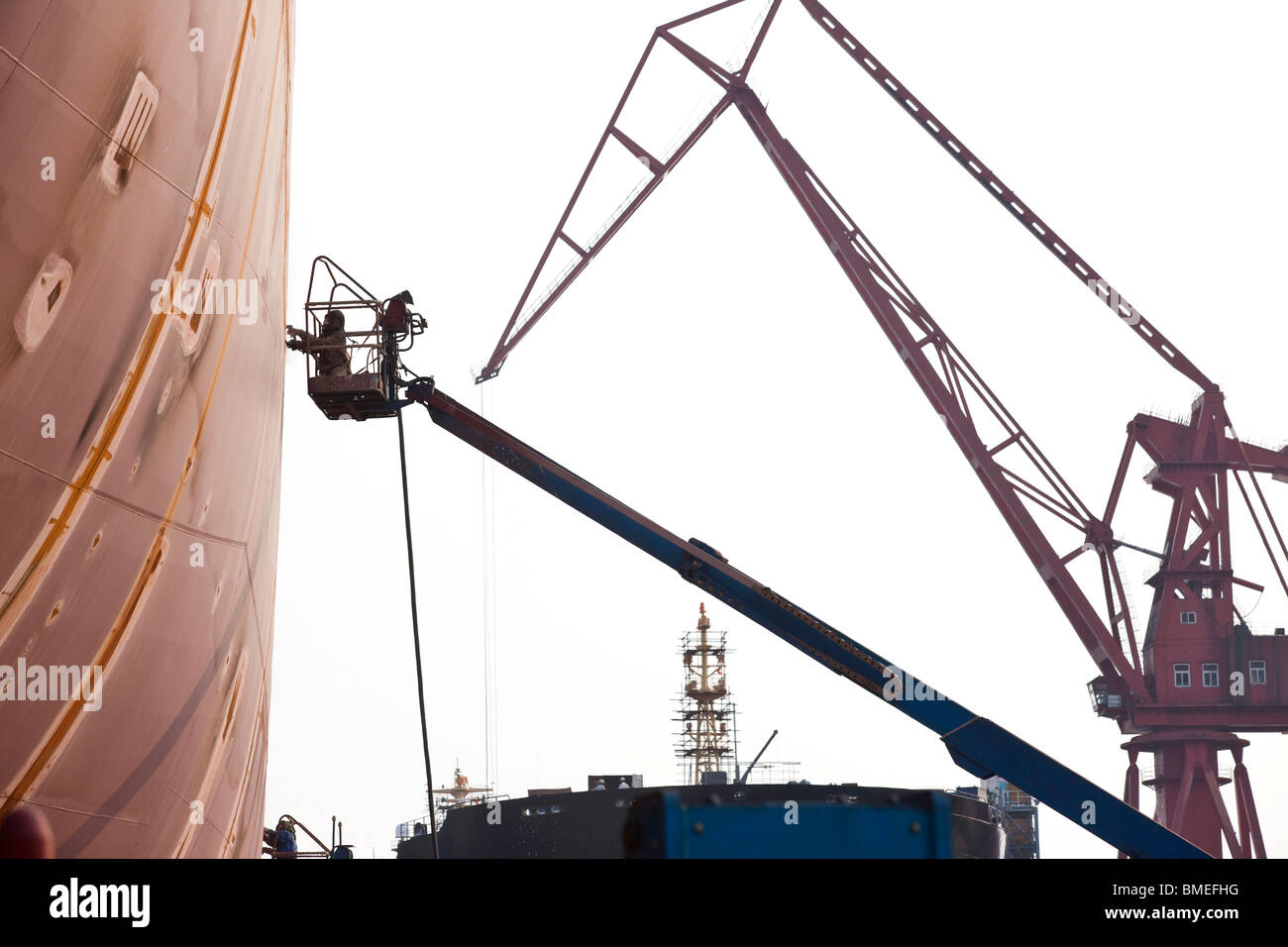 Workers working on the body of a large ship, Shanghai Waigaoqiao ...