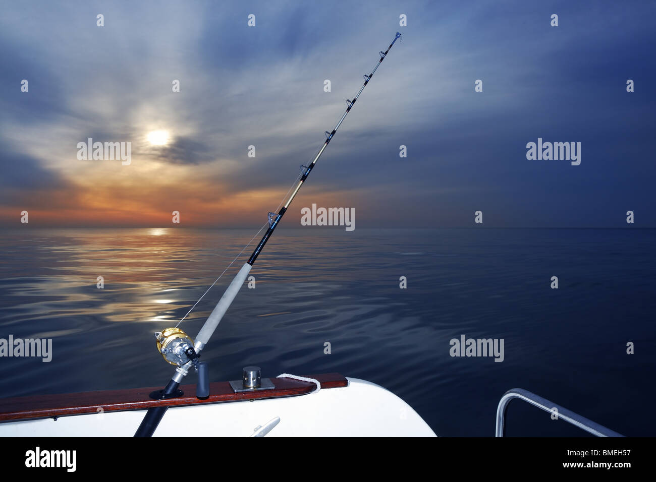 boat fishing sunrise on sea ocean rod and reels horizon Stock Photo - Alamy