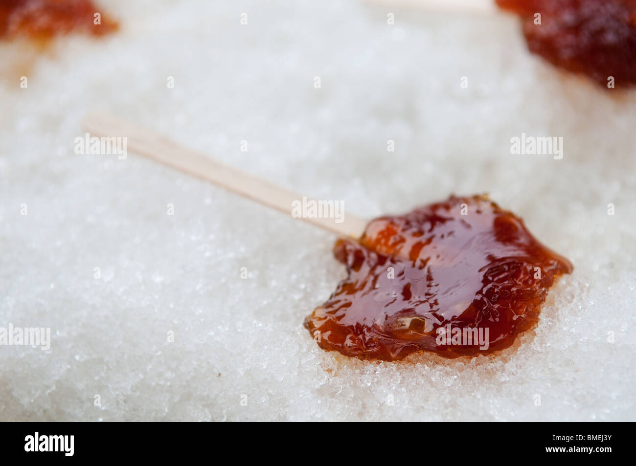 Sweet and sugary taffy sticks sitting in snowy ice Stock Photo - Alamy