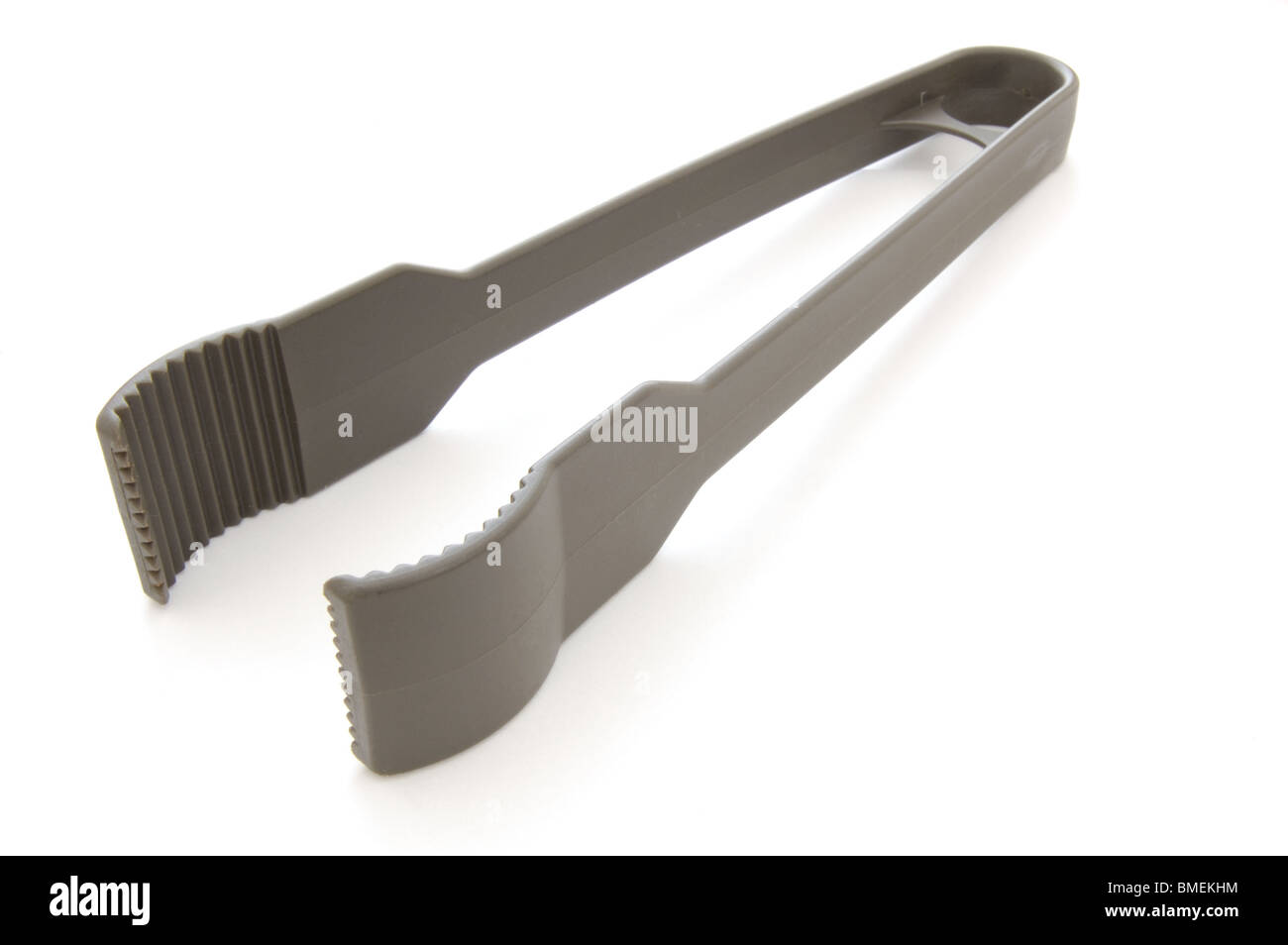 Plastic serving tongs isolated on a white background Stock Photo - Alamy