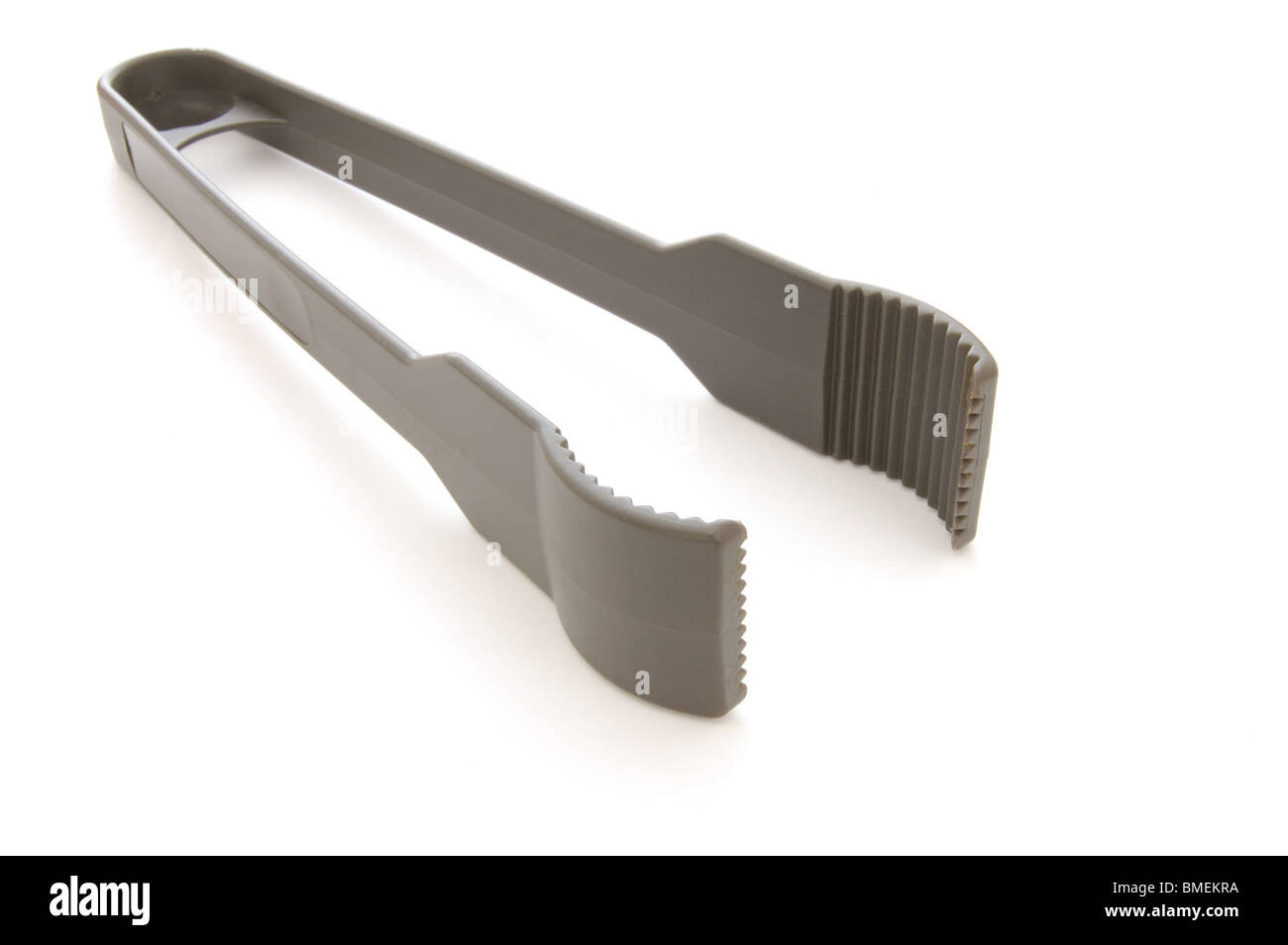 Plastic serving tongs isolated on a white background Stock Photo - Alamy