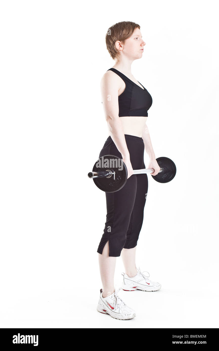 A young woman exercises on a white background Stock Photo - Alamy