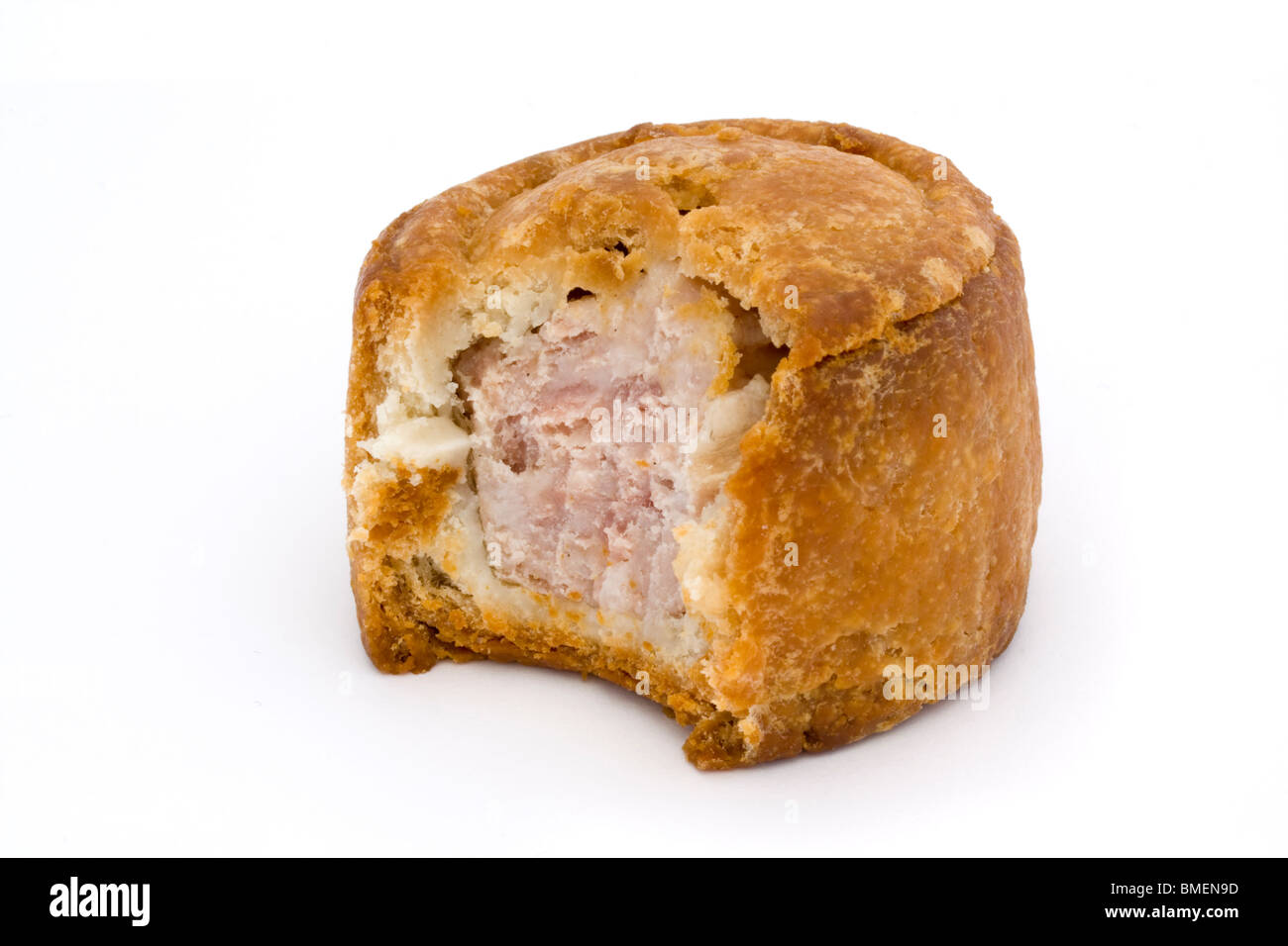 small pork pie with bite taken on a white background Stock Photo - Alamy