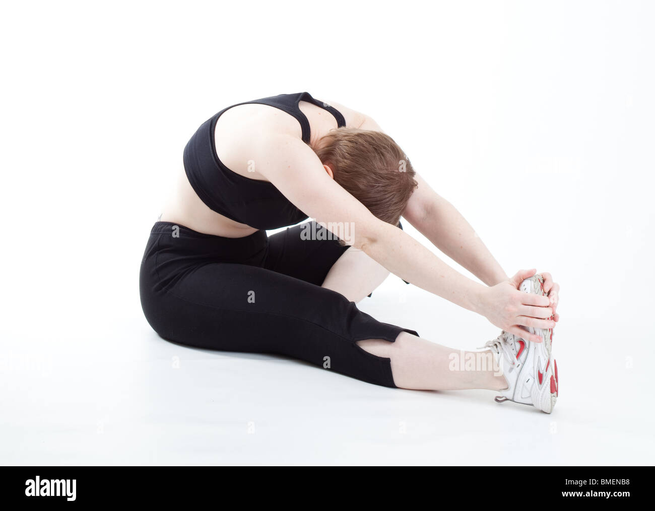 A young woman exercises on a white background Stock Photo - Alamy