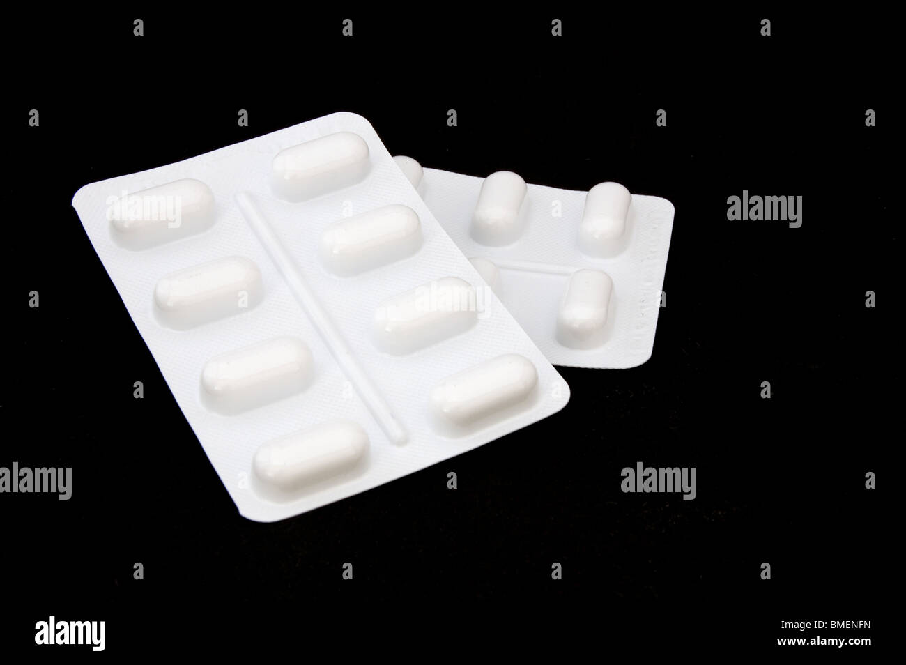 Tablet drug packets isolated on a black background Stock Photo - Alamy