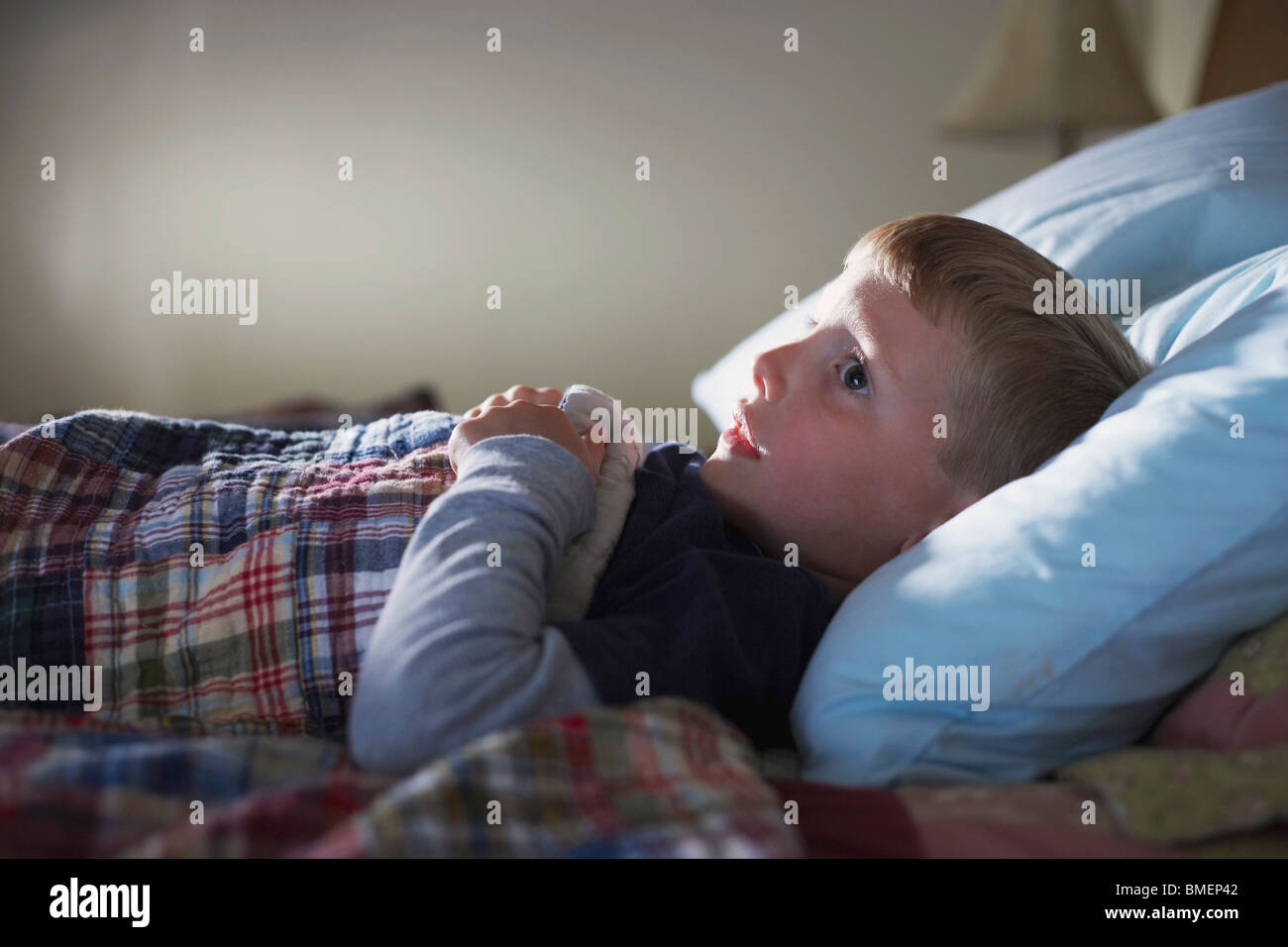 A Boy Laying Awake In Bed Stock Photo - Alamy