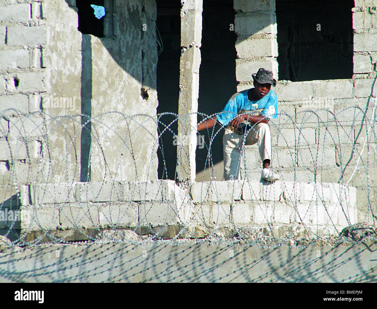 Haiti construction site behind razor wire Stock Photo - Alamy