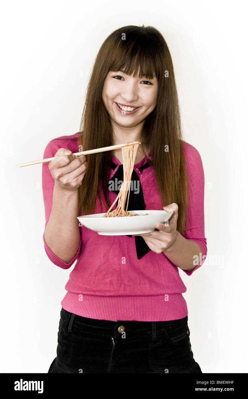 Chinese girl eating spaghetti Stock Photo - Alamy