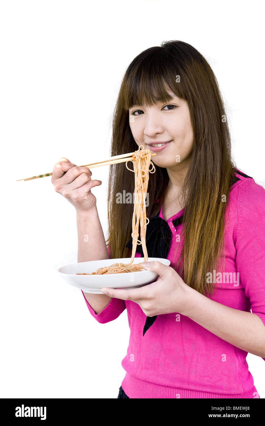 Chinese girl eating spaghetti Stock Photo - Alamy