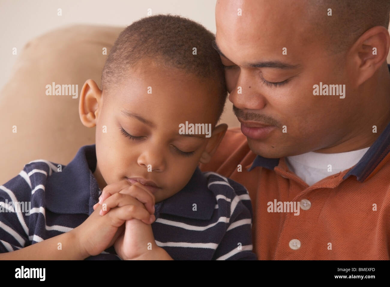 A Father And Son Praying Together Stock Photo - Alamy