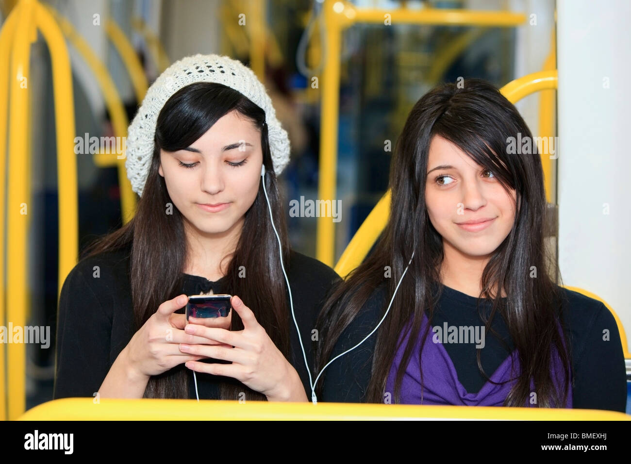 Portland, Oregon, United States Of America; Two Teenage Girls Listening ...