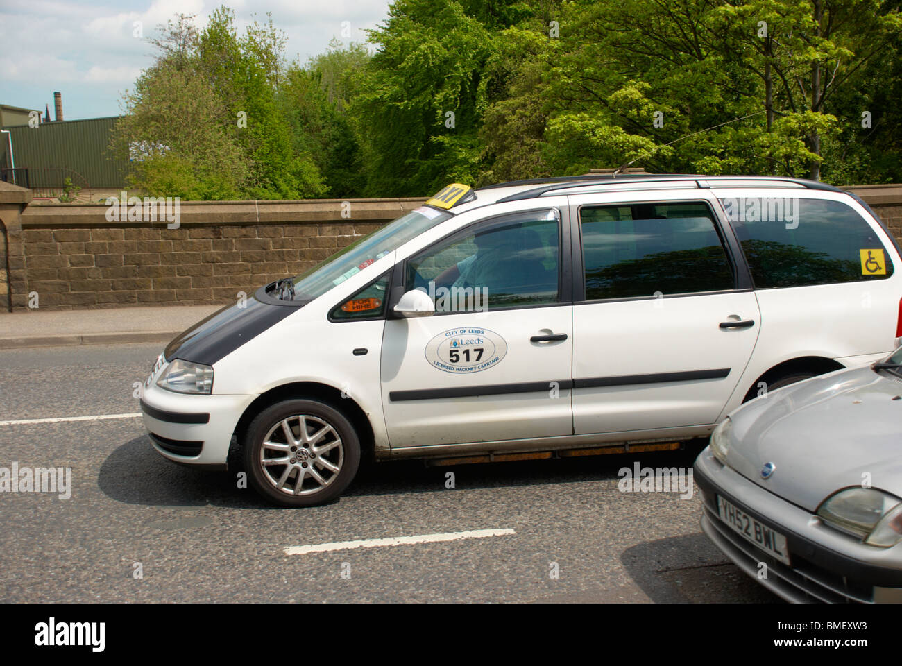 Taxi on the road in Huddersfield Stock Photo - Alamy