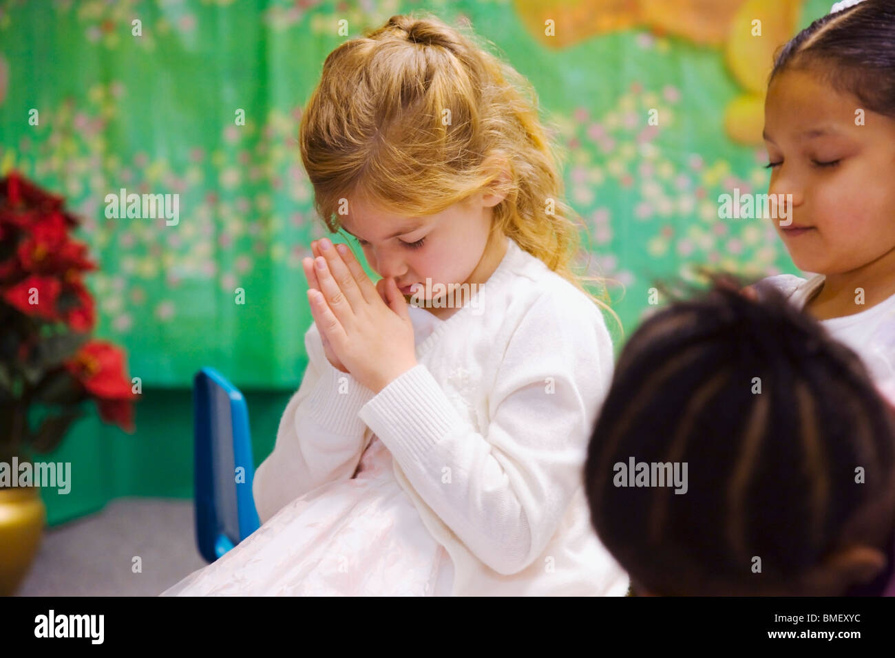 A Young Girl Bowing Her Head In Prayer Stock Photo - Alamy
