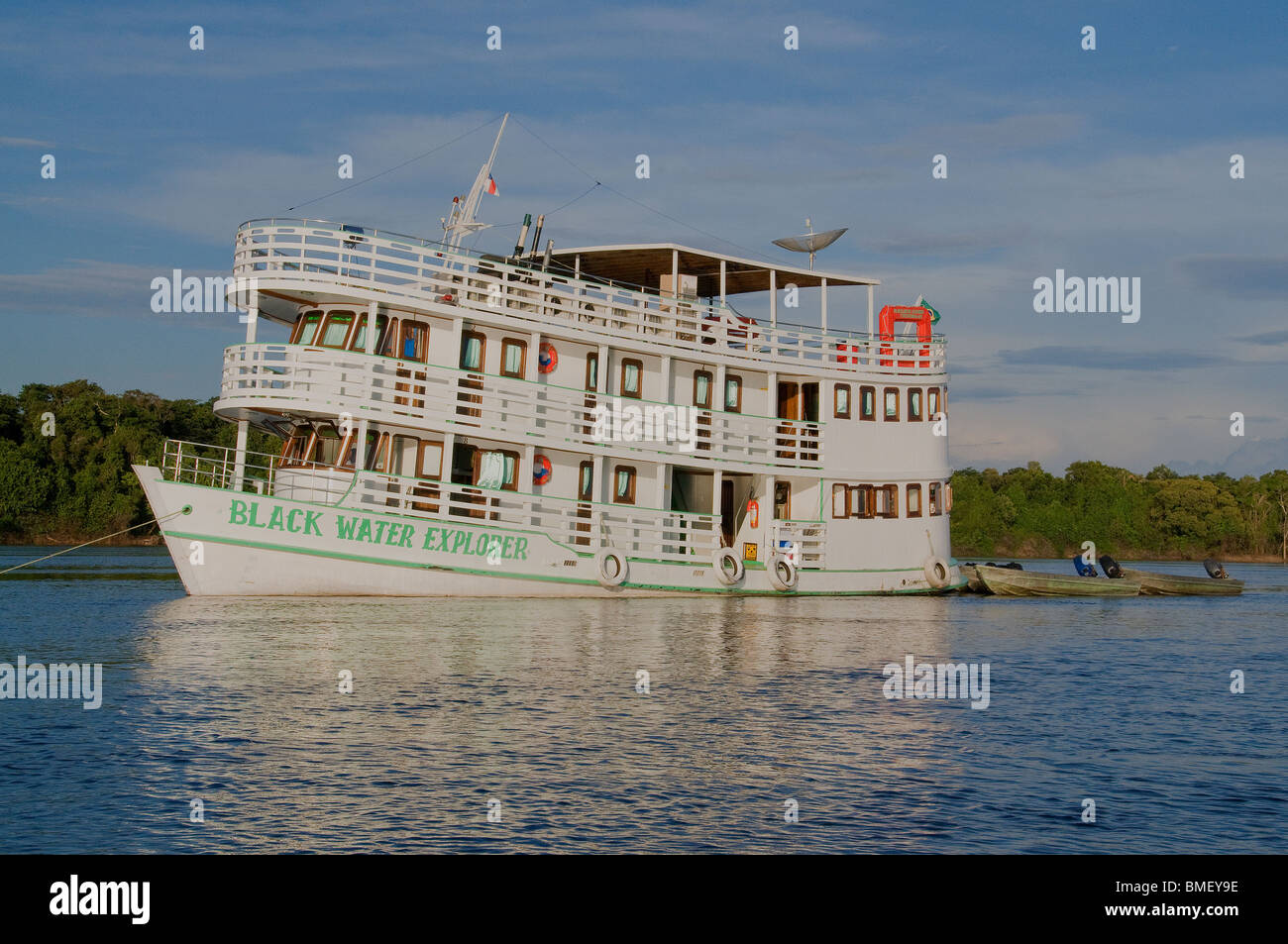 An Amazon River fishing yacht operation with bassboats in tow anchors ...