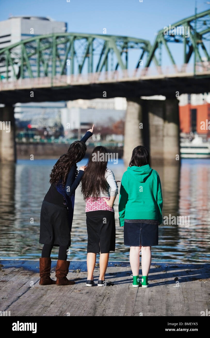 Portland, Oregon, United State Of America; Three Friends Looking At A ...
