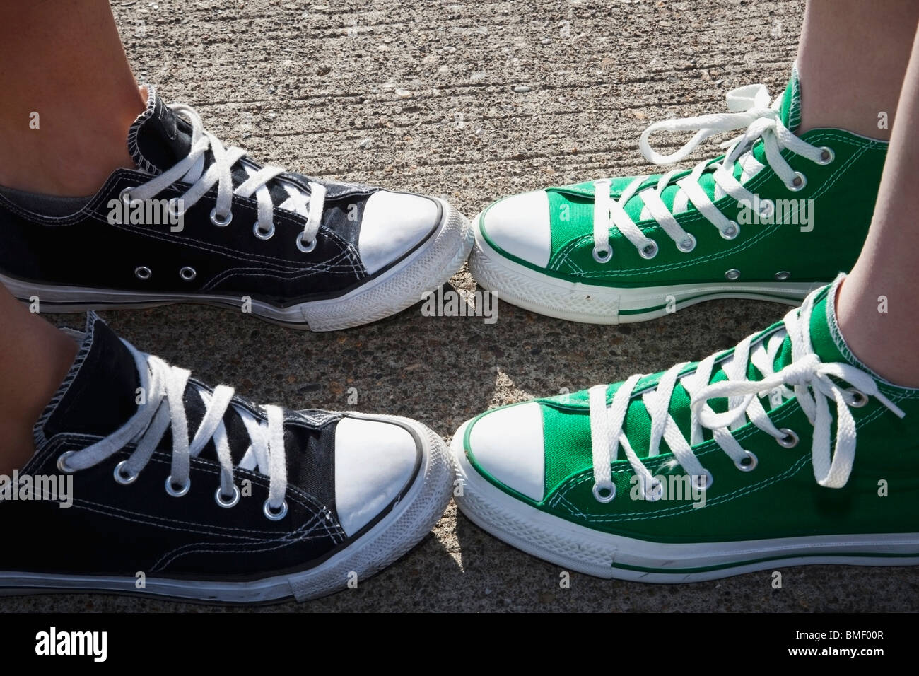 Feet Inside Two Pairs Of Lace Up Shoes Stock Photo - Alamy