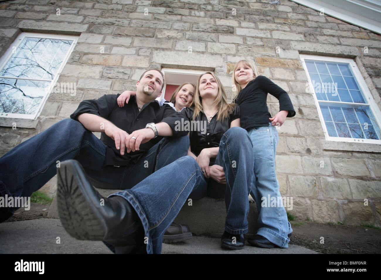 A Family Portrait In Front Of A Stone Building Stock Photo - Alamy
