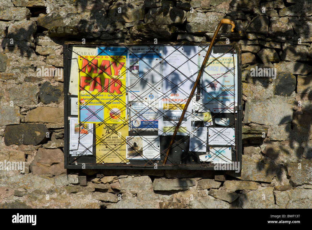 Parish notice board (with walking stick), Dacre village, Cumbria ...