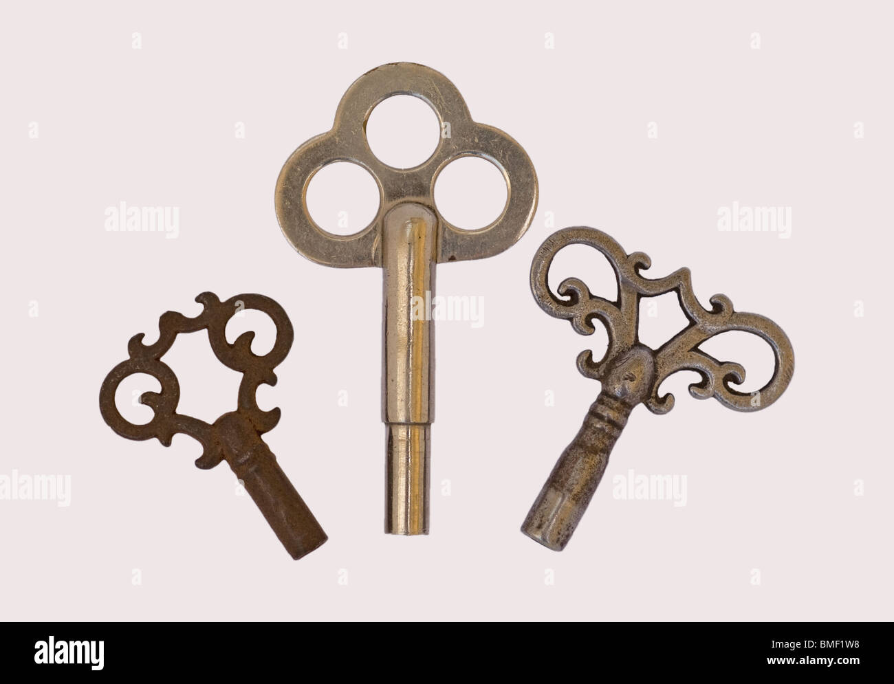 3 three antique ornate clock keys Stock Photo - Alamy