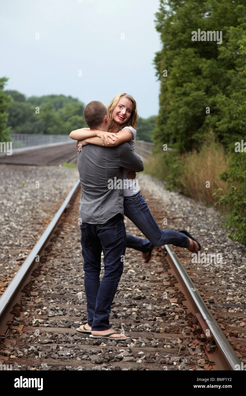 A Couple Hugging On The Train Tracks Stock Photo - Alamy