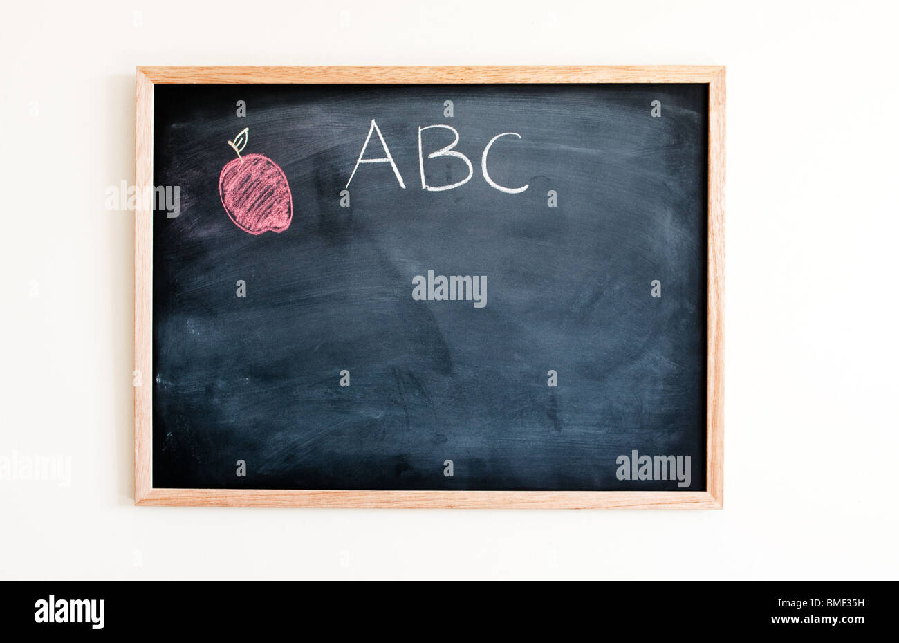 Red apple and ABC written on blackboard Stock Photo - Alamy