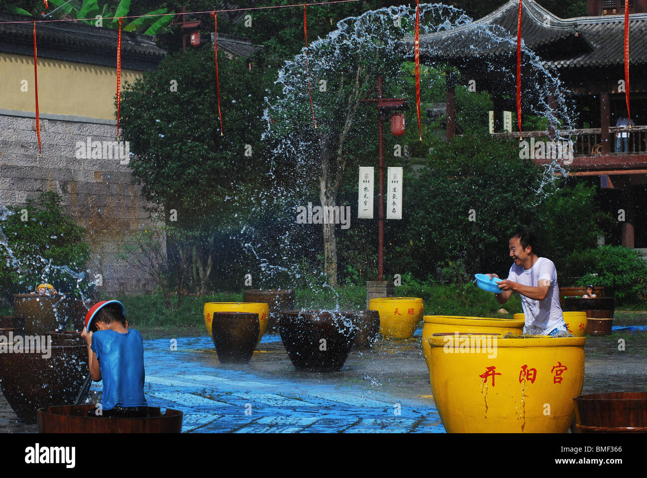 Tourists having fun during Water-splashing Festival, Xinchang Chongyang ...