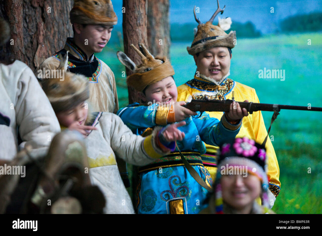 Oroqen boys playing with a shotgun, Oroqin Autonomous Banner, Hulunbuir ...