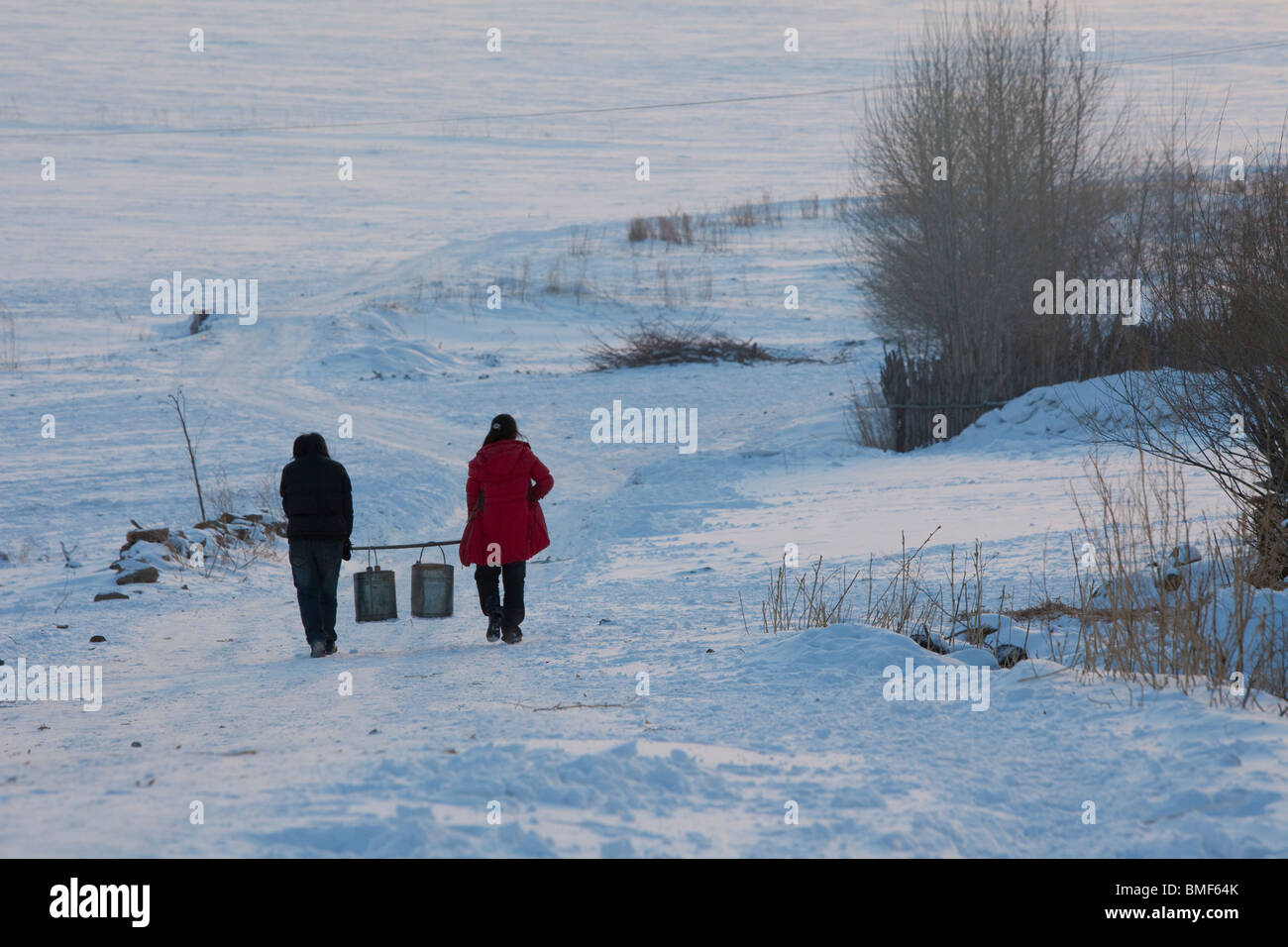 Oroqen people carrying water buckets in morning sunlight, Oroqin ...