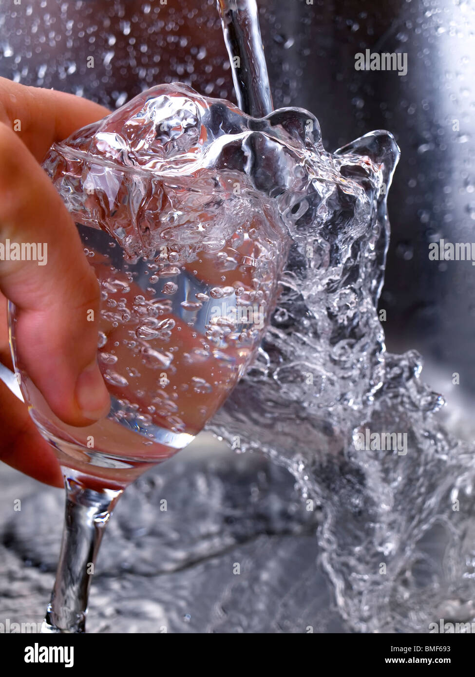 Moment during the filling of water in a glass Stock Photo - Alamy