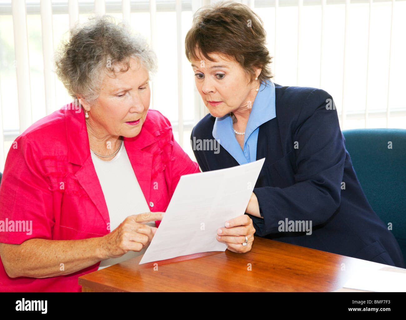 Worried couple discussing over agreement hi-res stock photography and ...