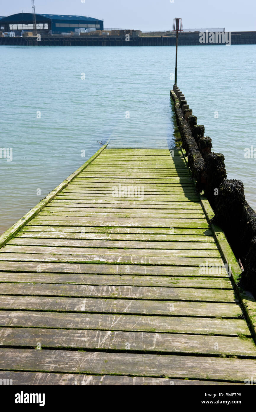 A wooden slipway, a sloping ramp for launching boats into the sea at ...