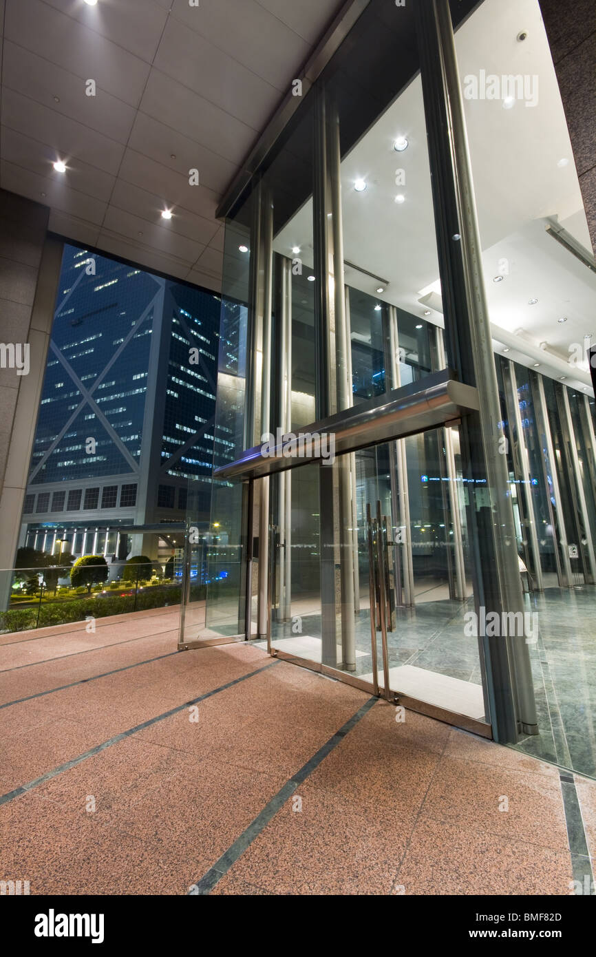 entrance of a modern building at night in hong kong Stock Photo - Alamy