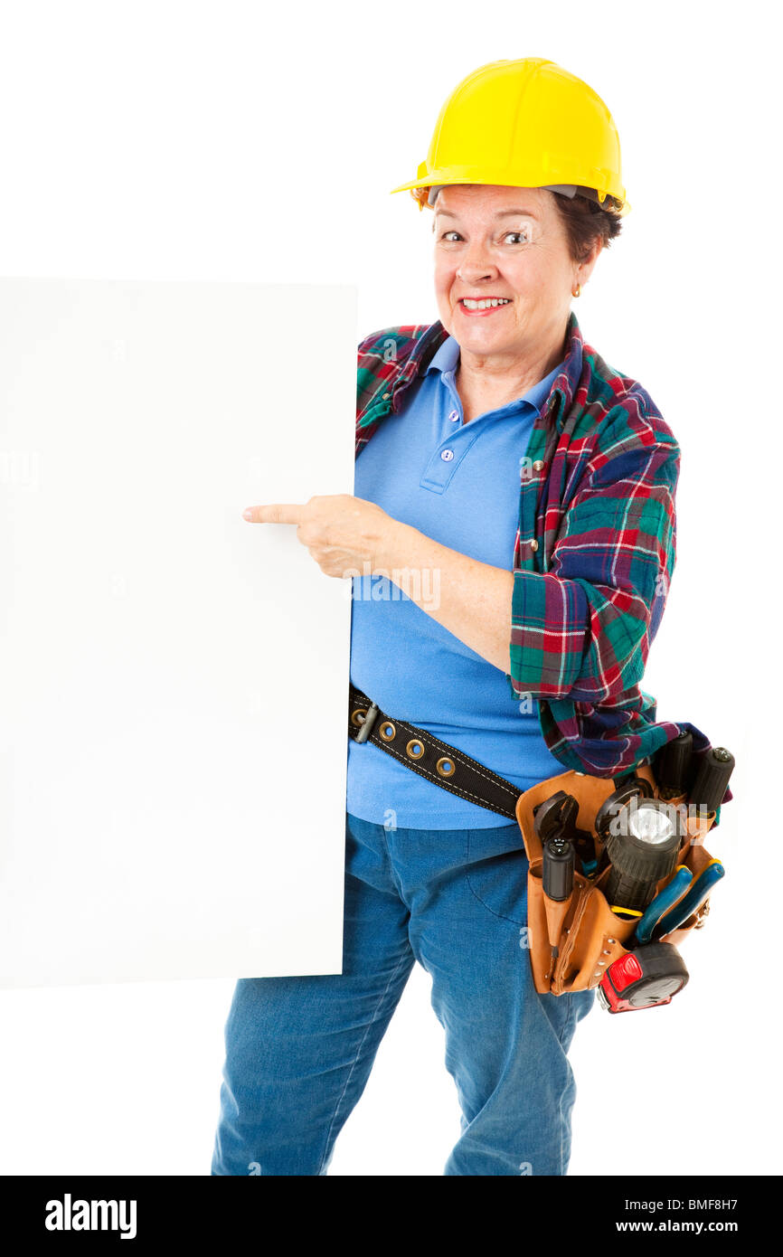 Female construction worker holding and pointing to a blank sign, ready ...