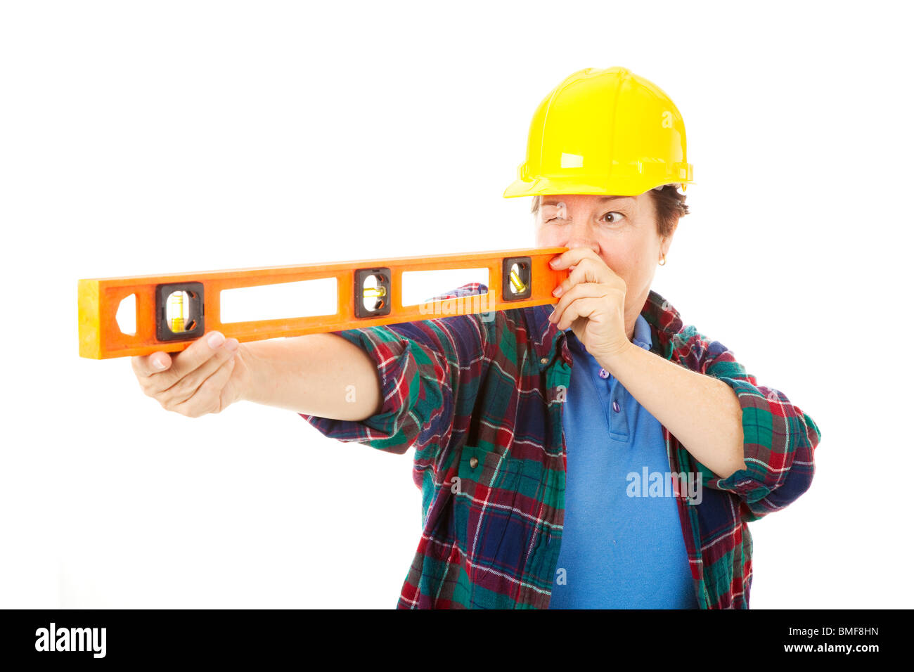 Female construction worker using a level. Isolated on white Stock Photo ...