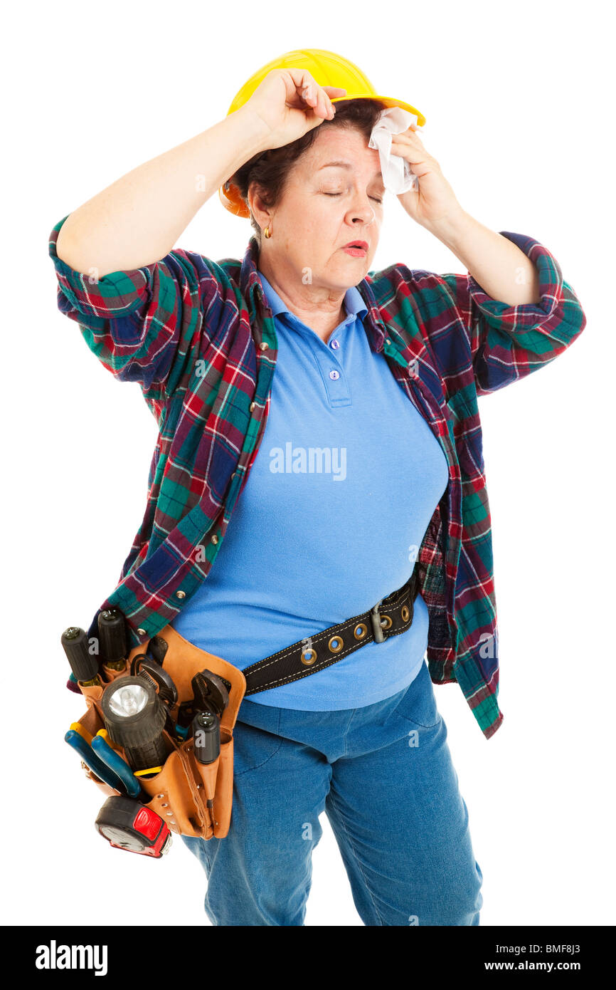 Tired female construction worker wipes sweat from her forehead Stock ...